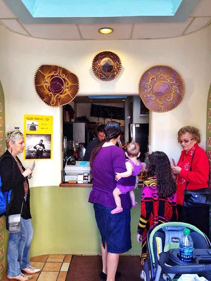 The heart of operations, where orders are called and hungry eyes watch. Those decorative sombreros have witnessed countless "Christmas" chile requests.