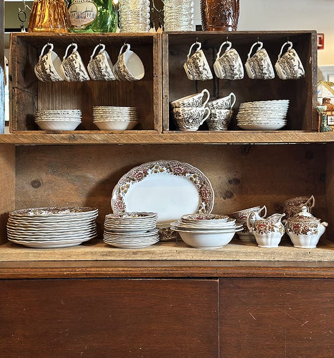 Vintage china displayed with museum-worthy precision offers complete sets that would make any dinner gathering instantly more elegant.