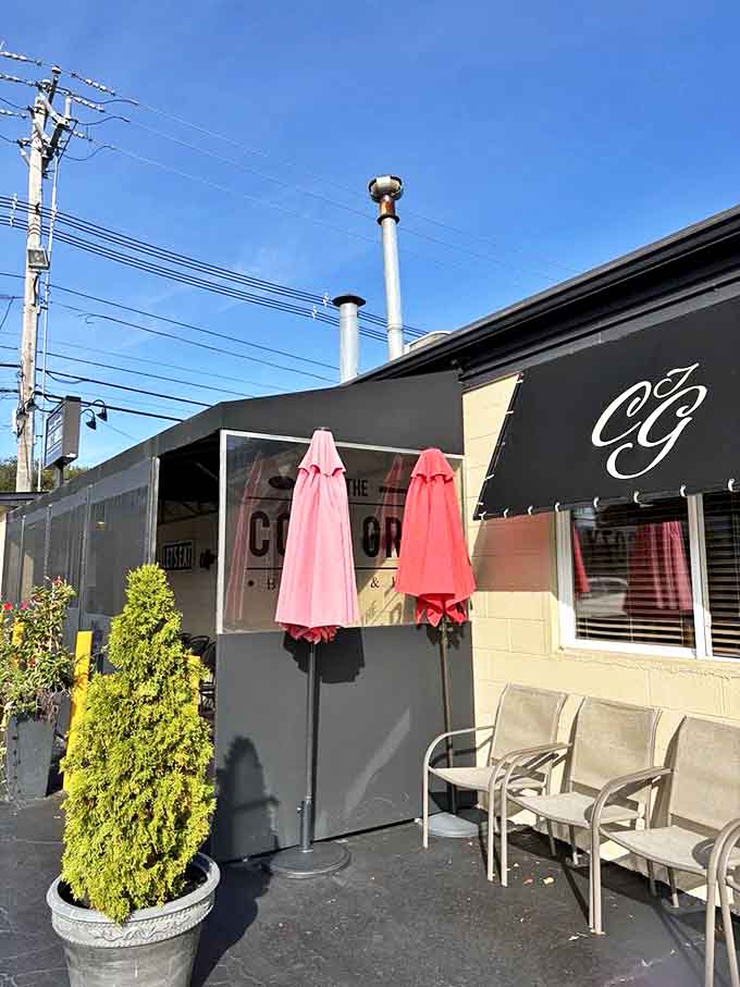 Morning sunshine highlights the welcoming entrance, where those signature black awnings and potted greenery set the stage for the breakfast performance waiting inside.