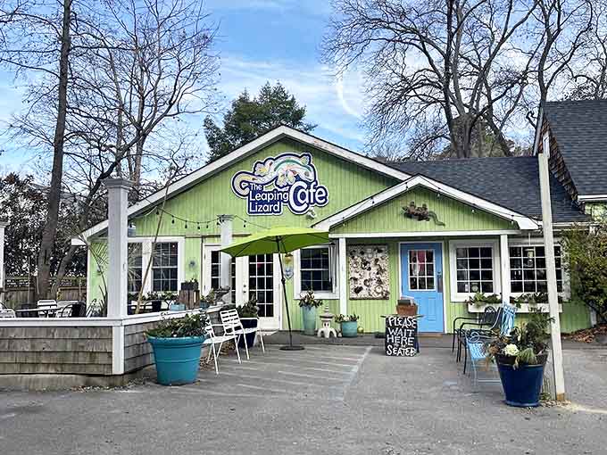Morning light reveals the cafe's cheerful personality. That turquoise door and mint-green exterior are basically saying "happiness served daily, come on in."