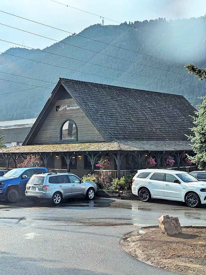 Nestled against the misty Teton backdrop, The Virginian's pitched roof and wraparound porch promise comfort food with a side of mountain majesty.