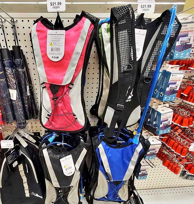 Hydration backpacks hanging like colorful promises of outdoor adventures that won't require a second mortgage to finance.