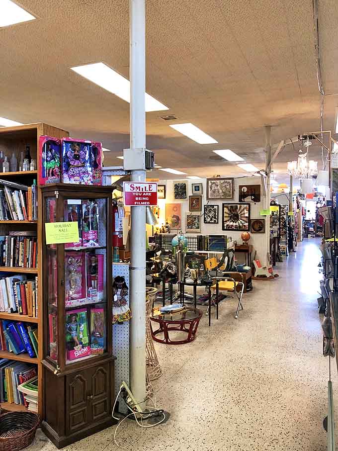 Barbie dolls from yesteryear keeping watch over an aisle of treasures &ndash; that "Smile, you're being filmed" sign is the only modern touch.
