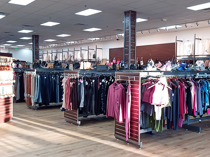 Sunlight streams across impeccably organized racks. The store's bright, airy layout makes browsing feel less like thrifting and more like boutique shopping.