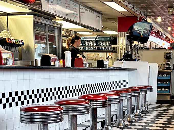 The counter seats&mdash;where solo diners become part of the diner's rhythm and the coffee refills flow like conversation.