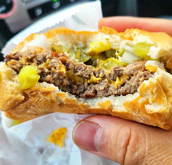 Peek inside burger perfection: those grilled onions nestled against the patty tell you everything about why Val's has survived while trendy spots come and go.