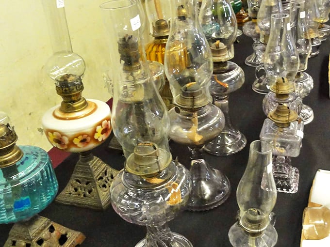 Vintage oil lamps that once illuminated family dinners now cast their glow as decorative treasures. Each glass chimney holds the warm light of nostalgia.