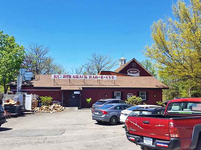 The parking lot view—where anticipation builds on arrival and satisfied patrons waddle happily to their cars after feasting.