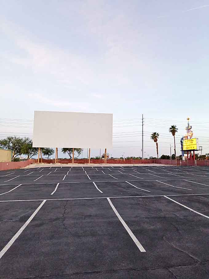 Empty in daylight, the lot transforms into a community by nightfall. Each parking space awaits its role in someone's perfect movie memory.
