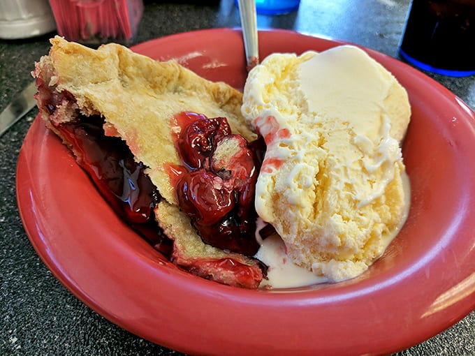 Cherry pie à la mode—the dessert equivalent of a warm hug from grandma, complete with flaky crust and ice cream melting into all the right places.
