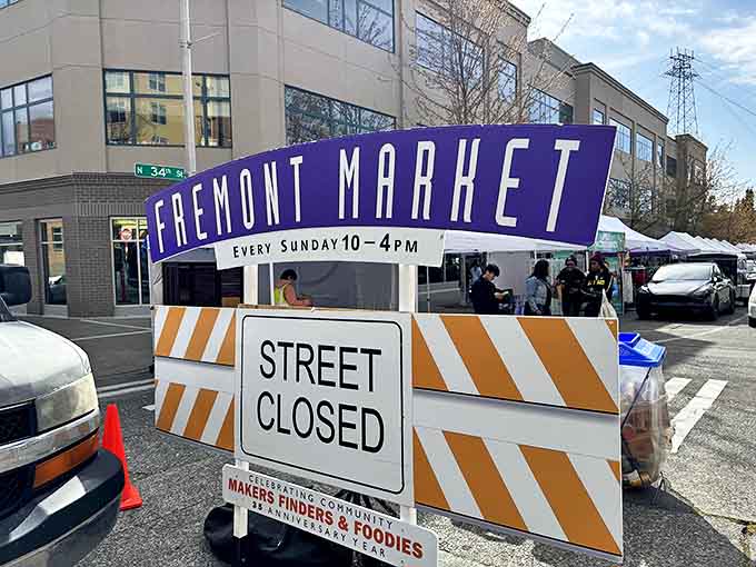 The iconic purple sign announces the weekly transformation of ordinary streets into extraordinary marketplace adventures.