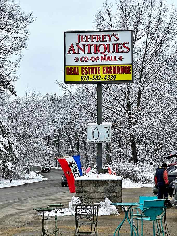 The snow-framed sign stands like a beacon for collectors. Jeffrey's Antiques: where Massachusetts winters meet warm nostalgia inside.