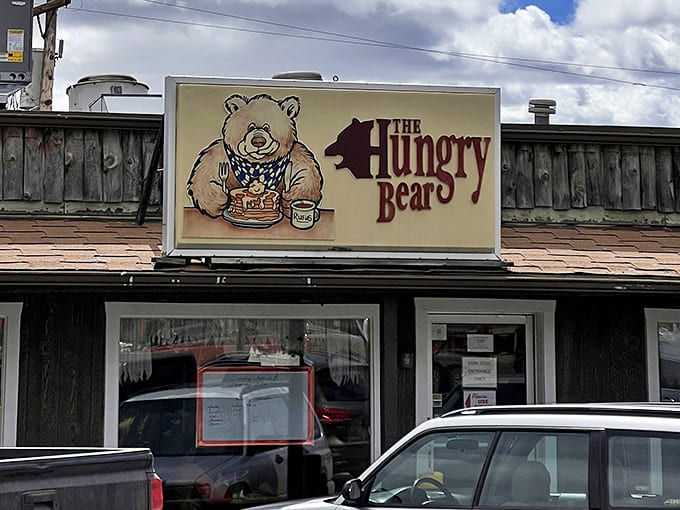 The sign says it all: a cartoon bear happily devouring pancakes, promising simple pleasures without pretension—exactly what you'll find inside.