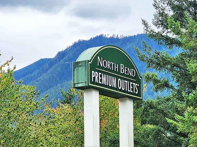 The North Bend Premium Outlets sign stands as a gateway to bargain paradise, framed by the mountains that make Washington special.