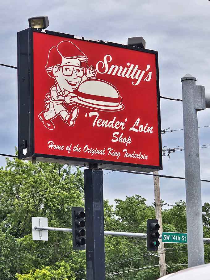 The cartoon chef proudly displays his creation. This street sign isn't just advertising; it's a beacon of hope for the hungry.