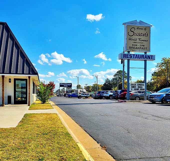 Susan's sign stands proud against cloud-dotted blue skies, like a breakfast lighthouse guiding the hungry masses to pancake paradise.