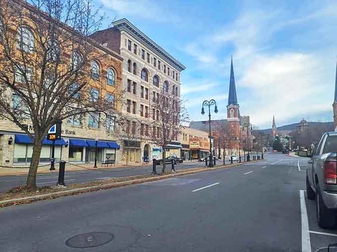 Main Street's historic buildings create a perfect small-town tableau, where church spires punctuate the skyline and mountains frame the background.