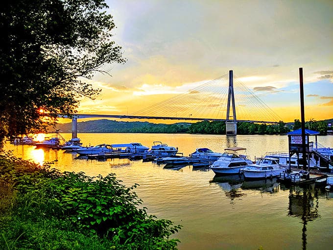 Sunset over the marina casts golden light on boats and bridge, a million-dollar view that comes standard with Huntington living.