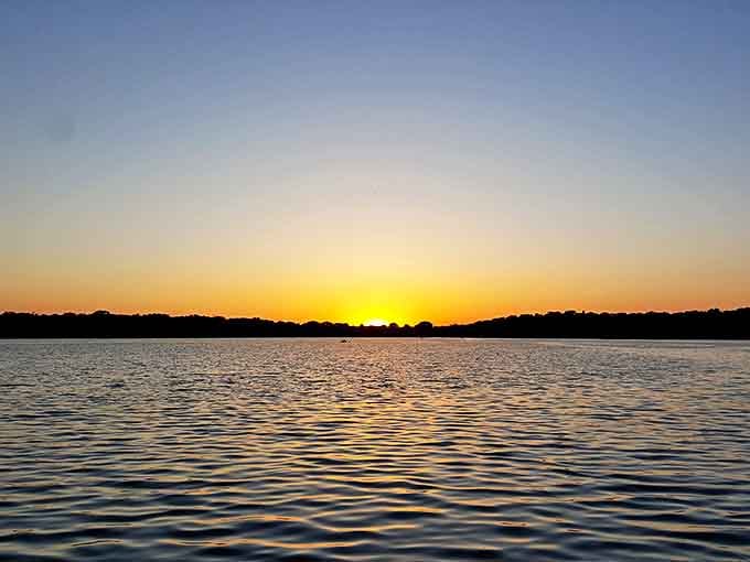 Sunset over Budd Lake &ndash; the nightly show that makes lakeside living in Fairmont worth every penny of your sensible mortgage.