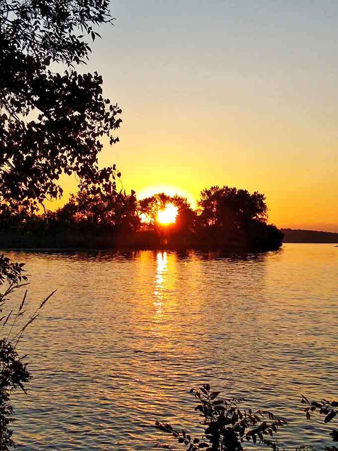 Sunset alchemy transforms Big Stone Lake into liquid gold, proving that South Dakota knows how to end a day with spectacular flair.