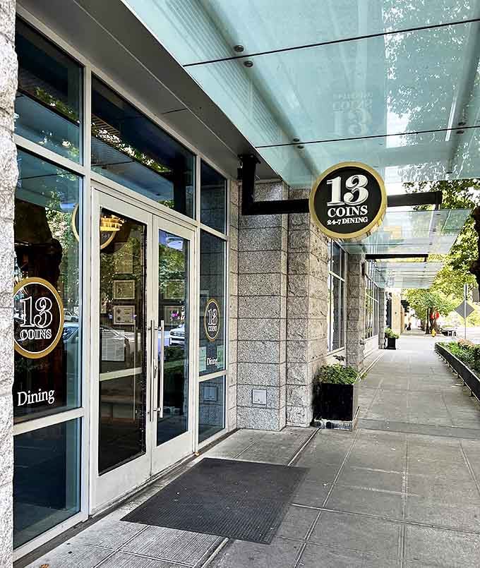 A warm welcome beckons at 13 Coins' entrance, where the iconic circular logo hints at the round-the-clock dining experience you're about to enjoy.