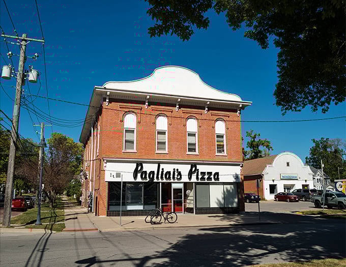 The historic brick facade of Pagliai's Pizza stands as a time capsule of Iowa City tradition, where pizza dreams come true daily.