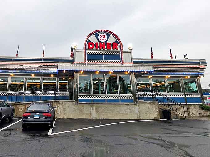 The Blue Colony Diner's gleaming facade promises 24-hour comfort food. Like a chrome time machine waiting to transport hungry travelers back to simpler times.