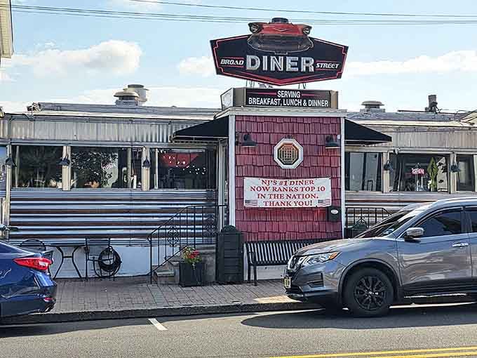 The Broad Street Diner gleams in the sunlight, a chrome time capsule where breakfast dreams come true and coffee cups never stay empty.
