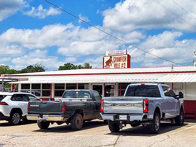 The unassuming exterior of Crawfish Hole #2 hides a seafood paradise. Those packed parking spots tell the real story!