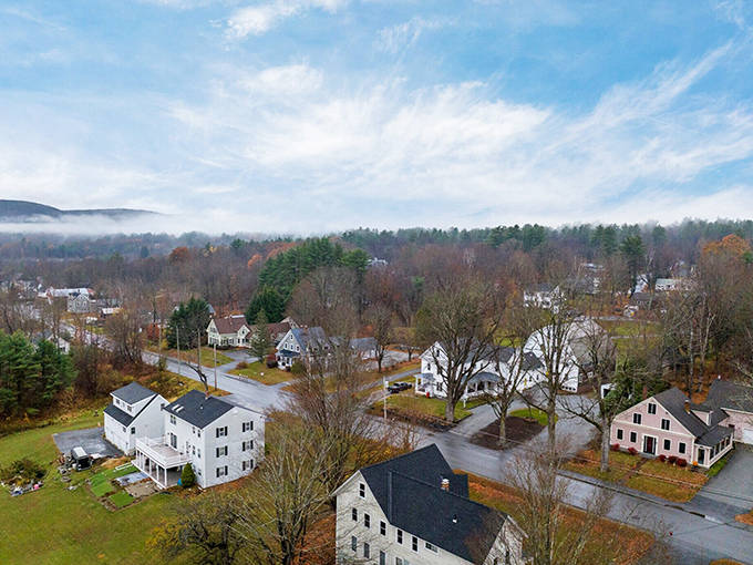 Henniker's aerial view reveals a quintessential New England town where white houses nestle among autumn trees like marshmallows in hot chocolate.