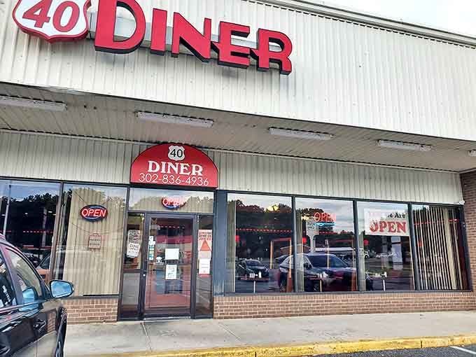 Route 40 Diner's iconic red sign promises what every road-weary traveler needs: honest food, bottomless coffee, and zero pretension.