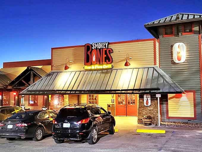 Smokey Bones glows like a BBQ beacon at dusk, promising ribs worth the journey and sauce worth the stains.
