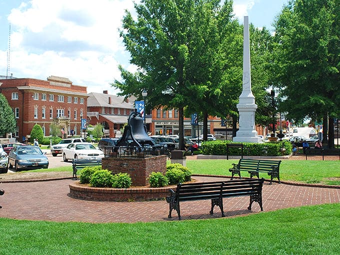 The town square bell stands sentinel in Abbeville, where park benches invite you to sit and watch the clouds drift by.