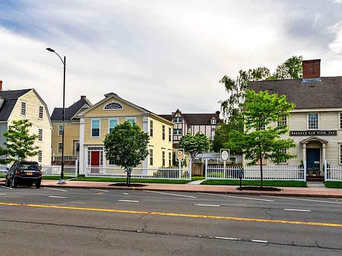 Classic New England charm lines these Middletown streets, where white picket fences aren't just decorative – they're a way of life.