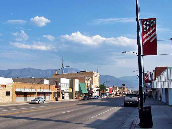 American flags flutter along Richfield's wide streets, where small-town charm meets big mountain views in perfect harmony.