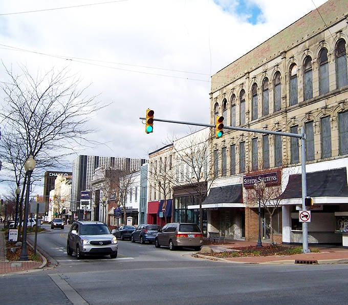 Classic brick buildings stand like patient sentinels, watching generations of families grow and flourish.