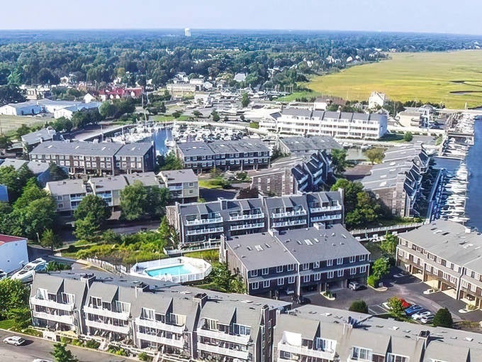Aerial views reveal a marina community where your morning coffee comes with water views that usually cost triple the price.
