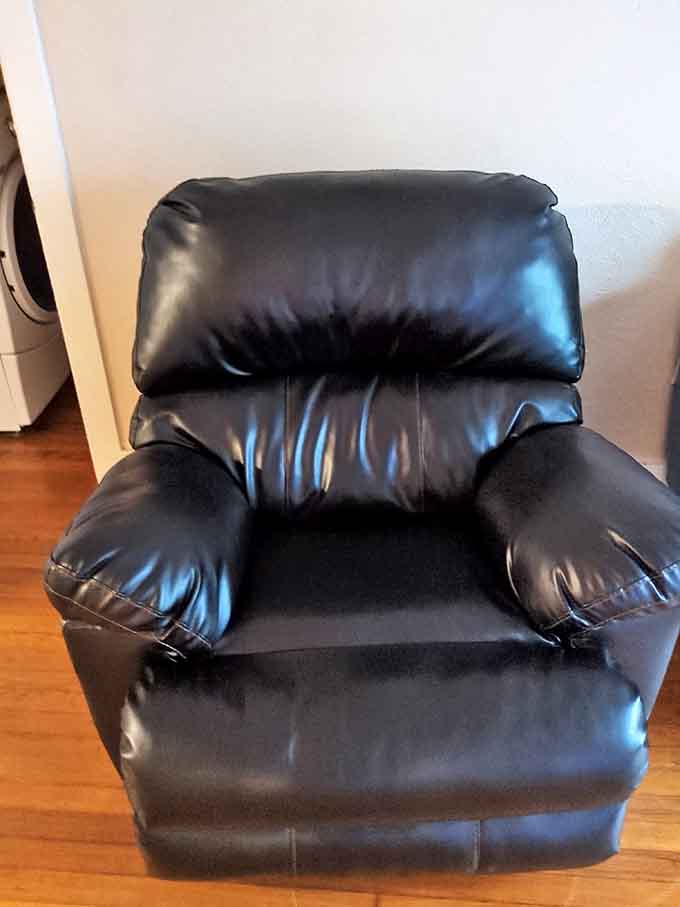 This black leather recliner isn't just furniture; it's your grandfather's favorite storytelling throne, priced to make room for tomorrow's memories.