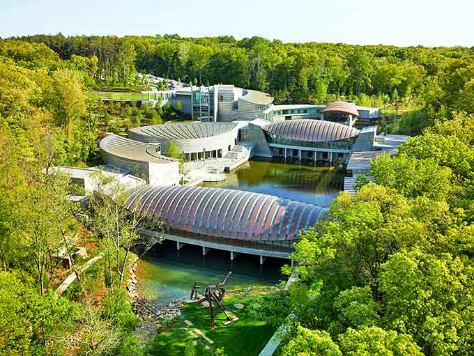 Crystal Bridges Museum emerges from the Ozark forest like a modernist dream, its curved pavilions floating above crystal-clear ponds in architectural harmony.