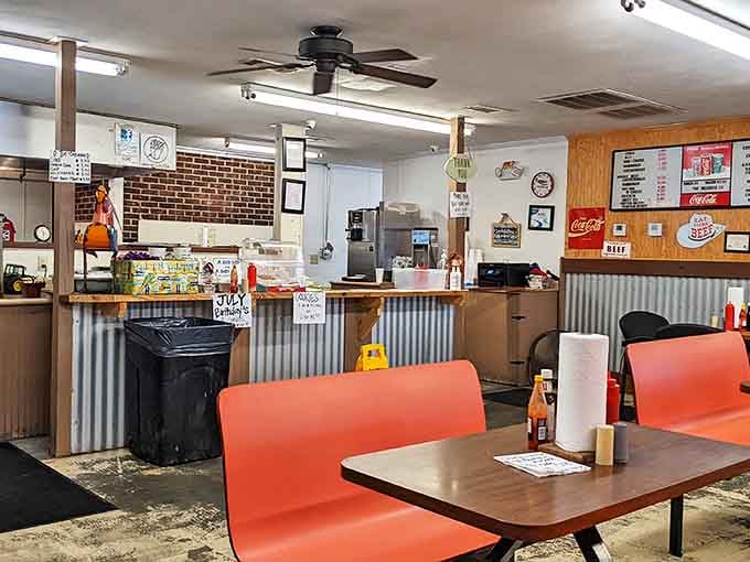 Inside, corrugated metal meets orange booths in a symphony of no-nonsense dining. This isn't Instagram-bait d&eacute;cor&mdash;it's the authentic stage where burger magic happens.