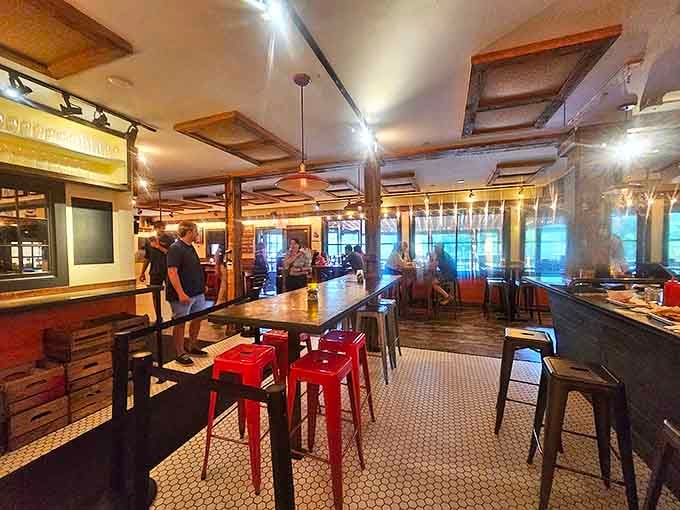 Industrial meets farmhouse in this warm interior where communal tables and red metal stools invite strangers to become friends over exceptional food.