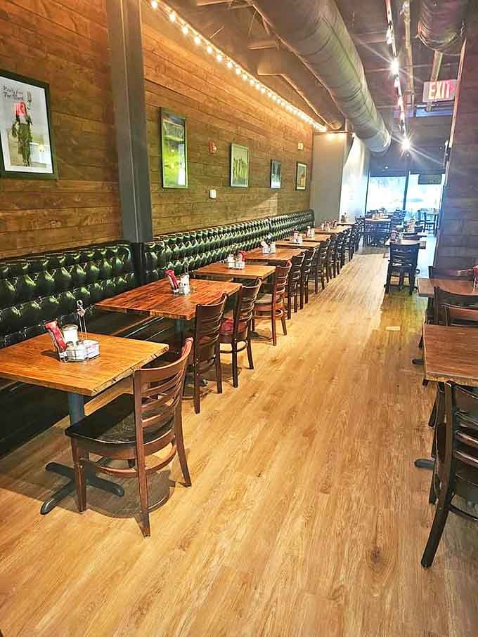 Green leather booths against warm brick walls create that perfect "where everybody knows your name" vibe, minus Norm and Cliff.