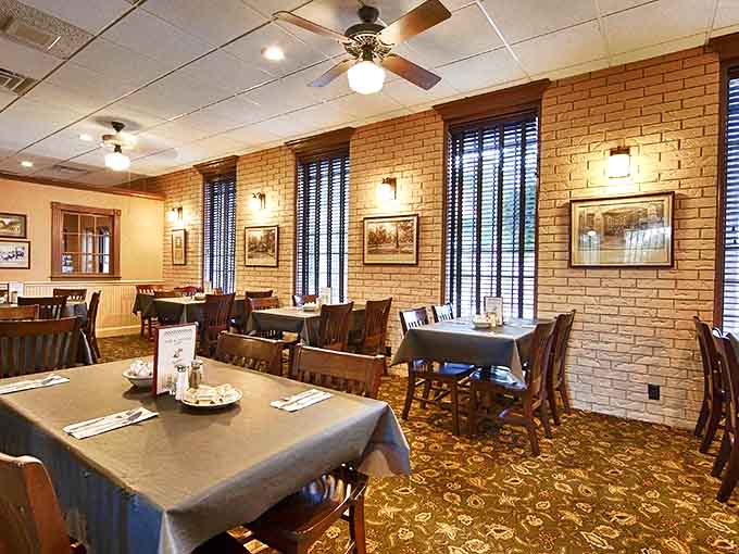 Warm brick walls, comfortable seating, and natural light create that "grandma's dining room for 100" vibe that makes everyone feel at home.