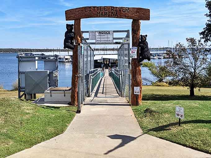 The Little River Marina entrance, guarded by wooden bears, welcomes you to Lake Thunderbird's peaceful waters. Boating paradise or fishing haven? Why choose?