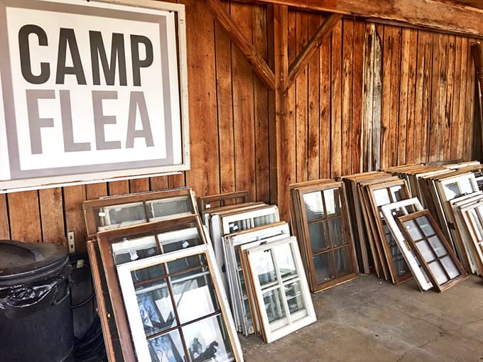 The "Camp Flea" sign says it all—this isn't shopping, it's an expedition. Those salvaged windows could frame your next great view.