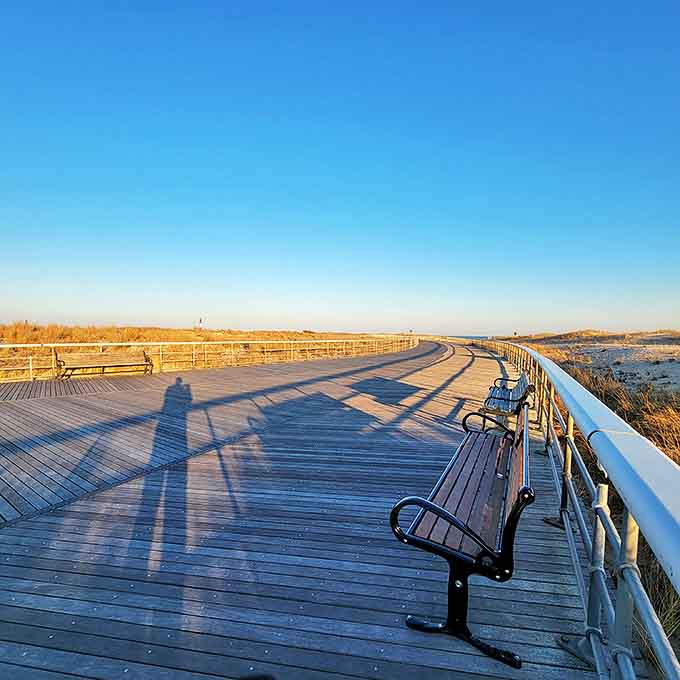 Golden hour transforms this simple boardwalk into a pathway to serenity. Those benches aren't just seating&mdash;they're front-row tickets to nature's daily masterpiece.