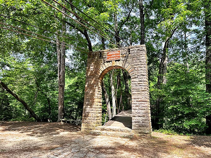 The CCC-built stone arch stands as a portal between everyday stress and woodland serenity. No password required for entry.