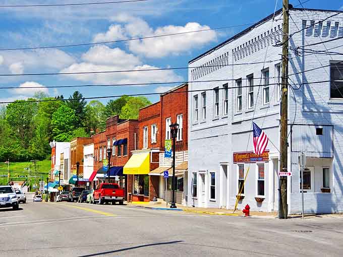 Colorful storefronts line this small-town street, where local businesses have survived the big-box invasion that claimed so many Main Streets.