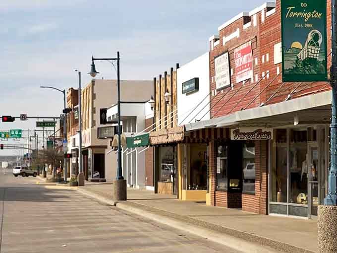 Torrington's Main Street storefronts maintain their mid-century charm, complete with a welcoming town banner. Norman Rockwell would feel right at home here.