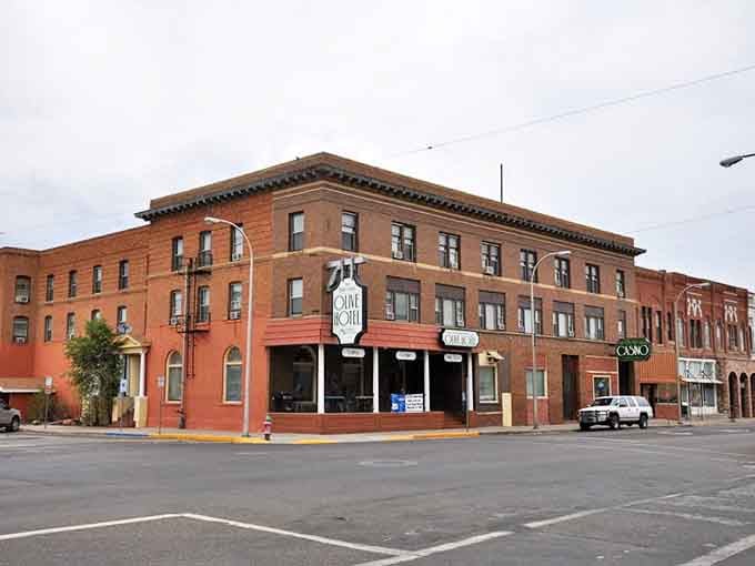 The Range Riders Bar sign beckons like an old friend. These brick facades have witnessed generations of cowboys, ranchers, and locals sharing stories over cold drinks.